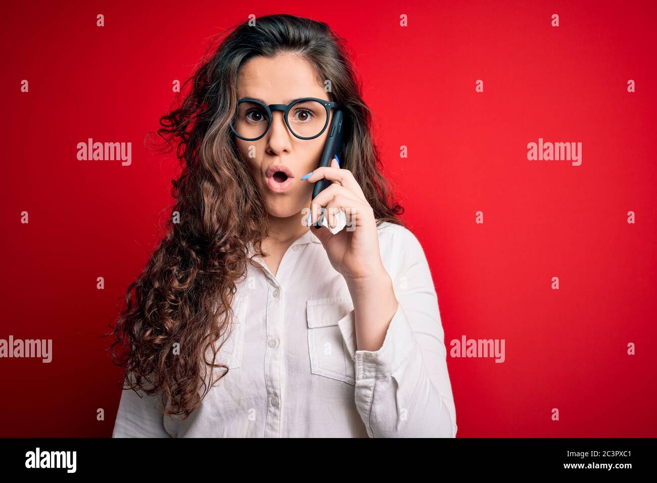 Young beautiful woman with curly hair having conversation talking on ...