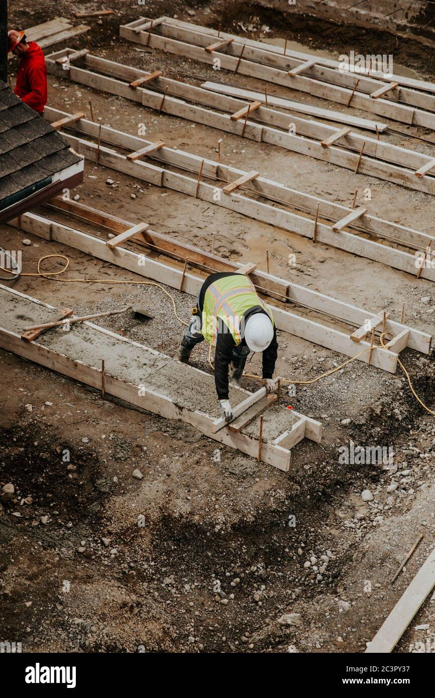 Workers in the construction site Stock Photo - Alamy