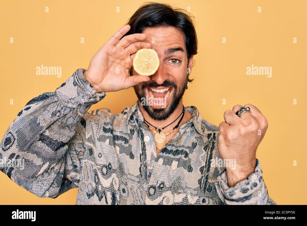 Young handsome hispanic bohemian hipster man with bear holding fresh ...