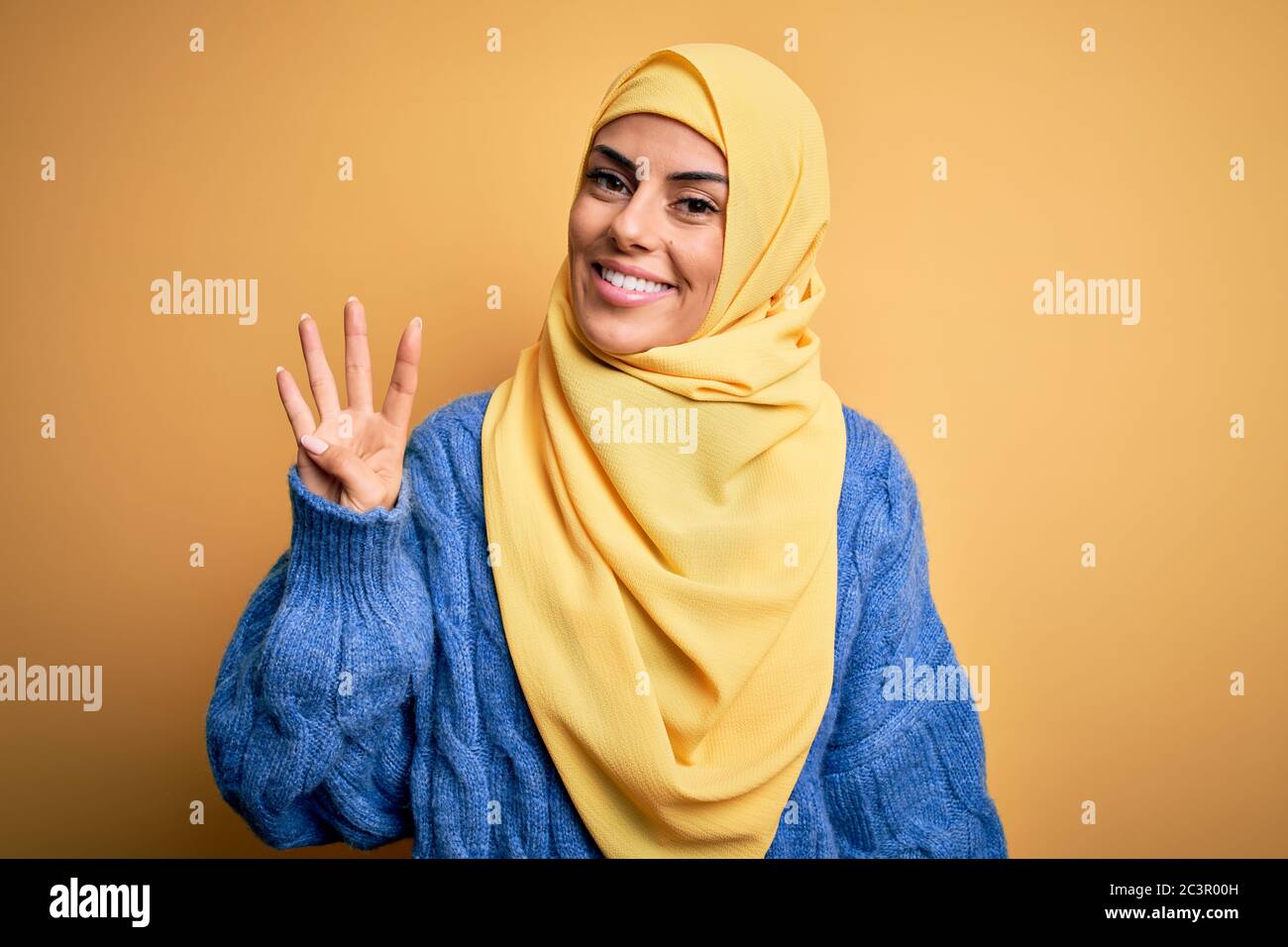 Young beautiful brunette muslim woman wearing arab hijab over isolated ...