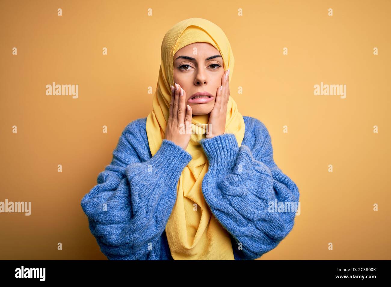 Young beautiful brunette muslim woman wearing arab hijab over isolated ...