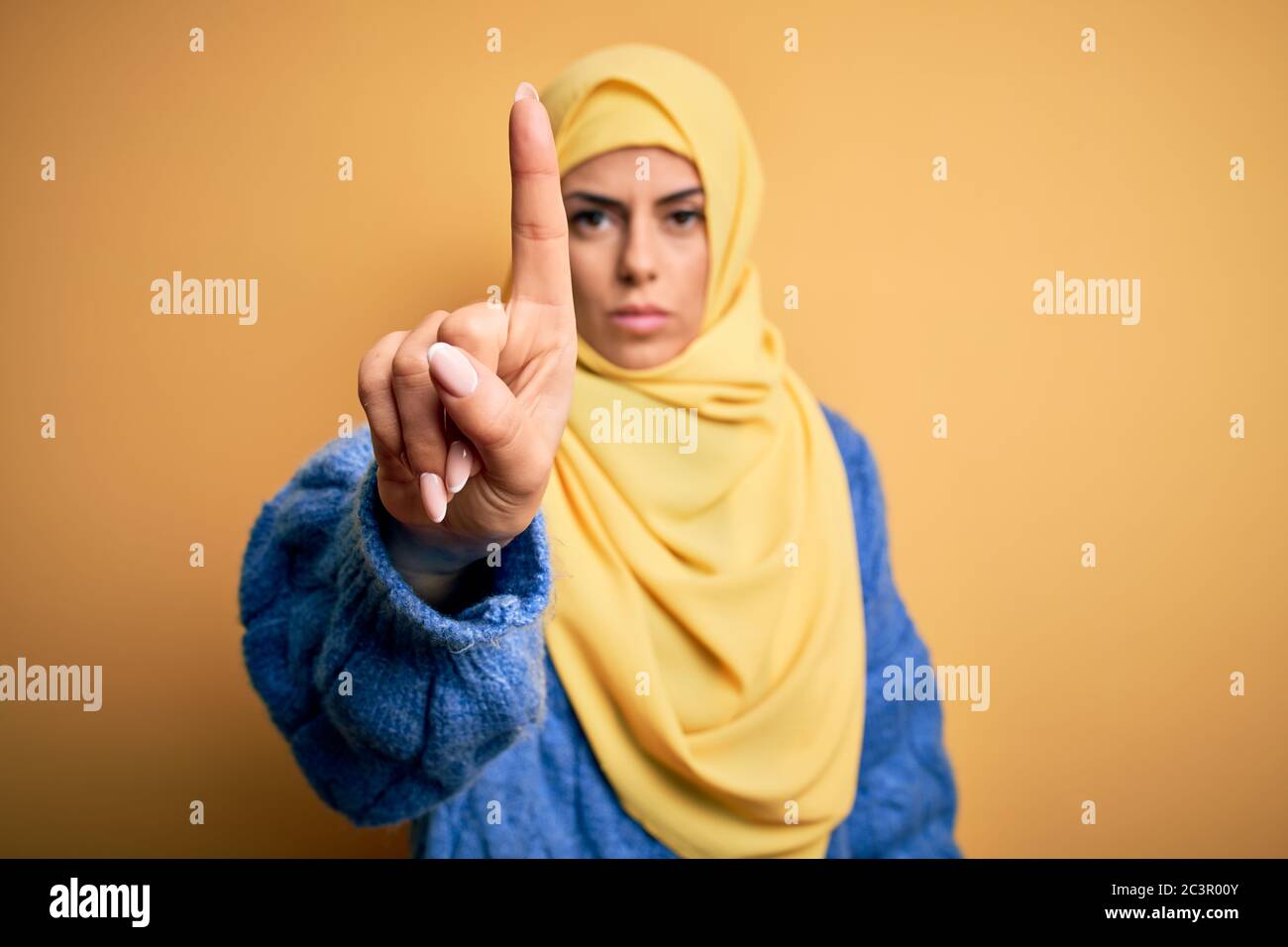 Young beautiful brunette muslim woman wearing arab hijab over isolated ...