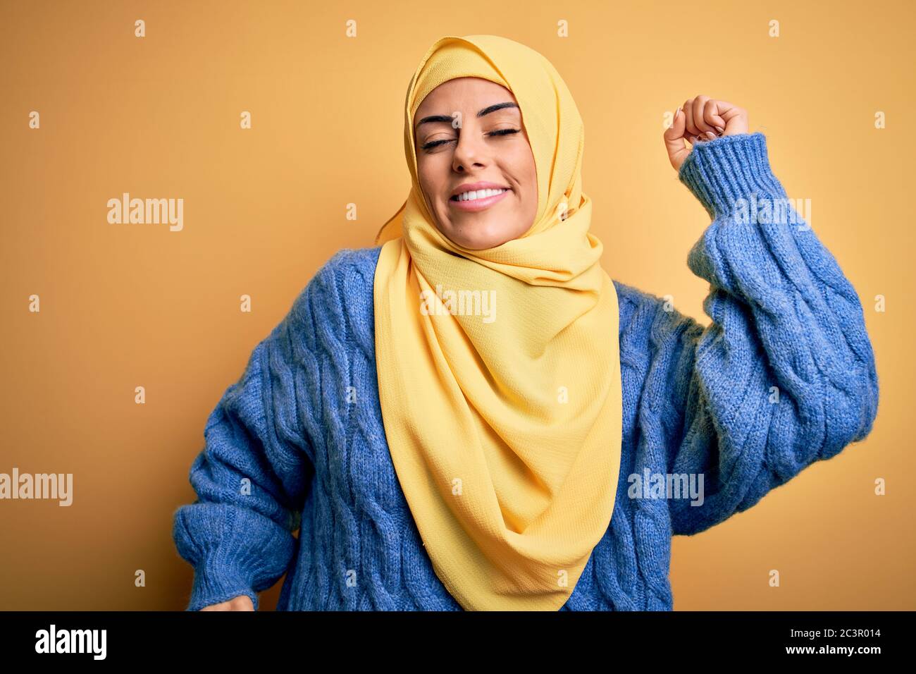 Young beautiful brunette muslim woman wearing arab hijab over isolated ...