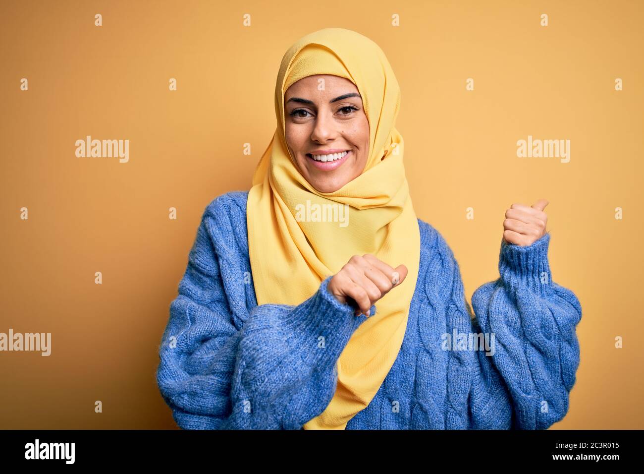 Young beautiful brunette muslim woman wearing arab hijab over isolated ...