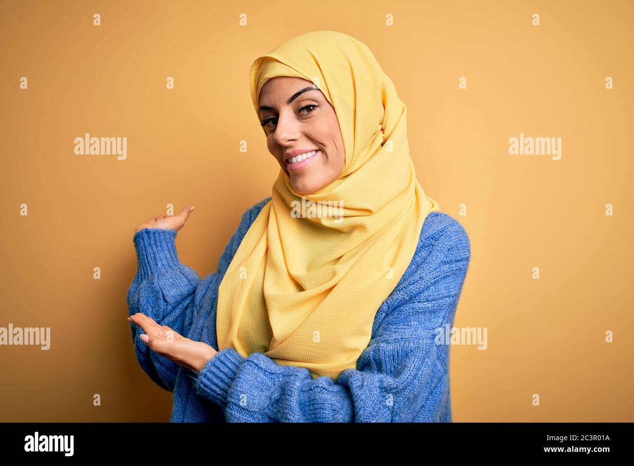 Young beautiful brunette muslim woman wearing arab hijab over isolated ...