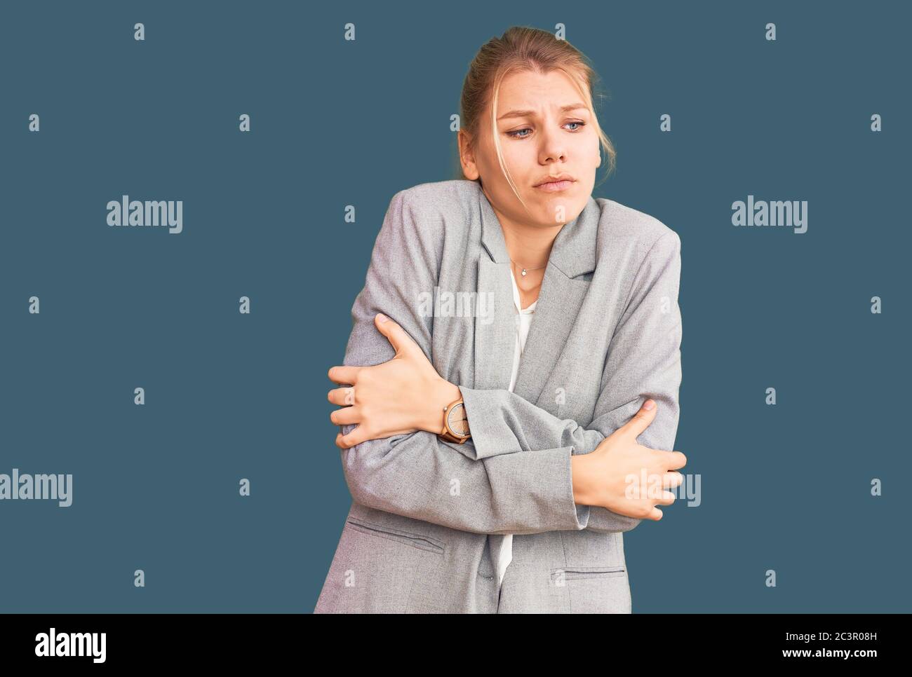 Young beautiful blonde woman wearing elegant jacket shaking and ...