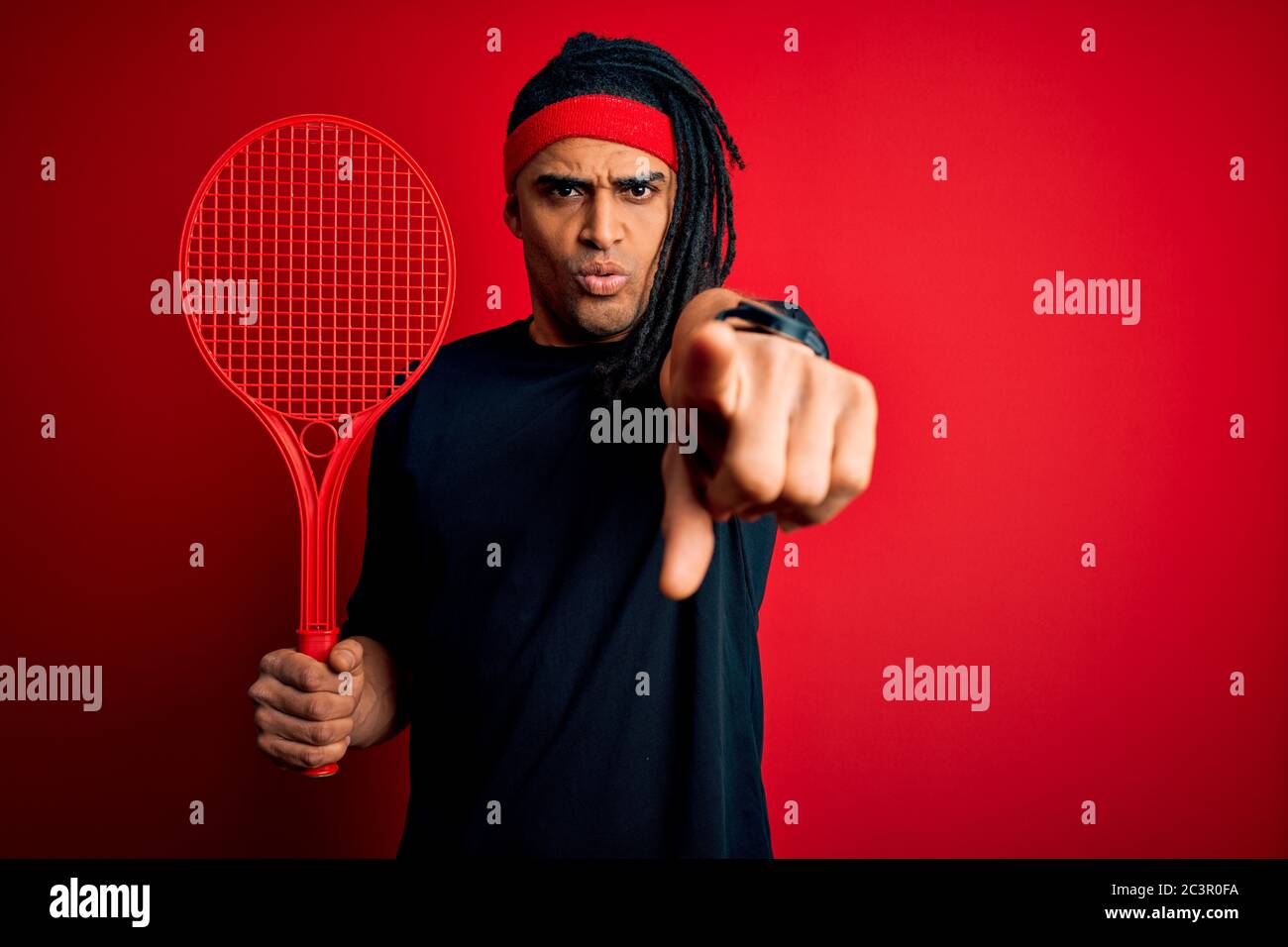 African american afro sportsman with dreadlocks holding tennis racket ...