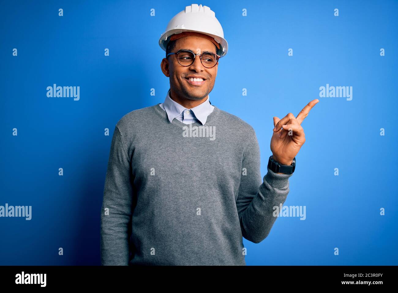 Young handsome african american engineer man with dreadlocks wearing ...