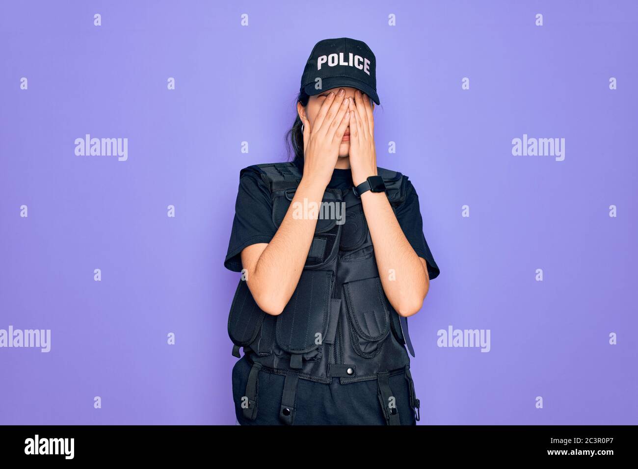 Young police woman wearing security bulletproof vest uniform over ...