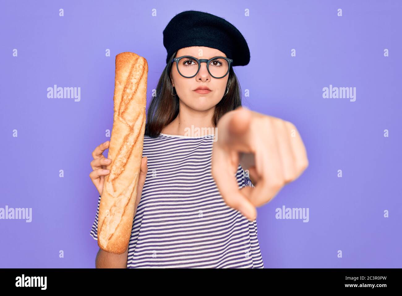 Young beautiful girl wearing fashion french beret holding fresh baked ...