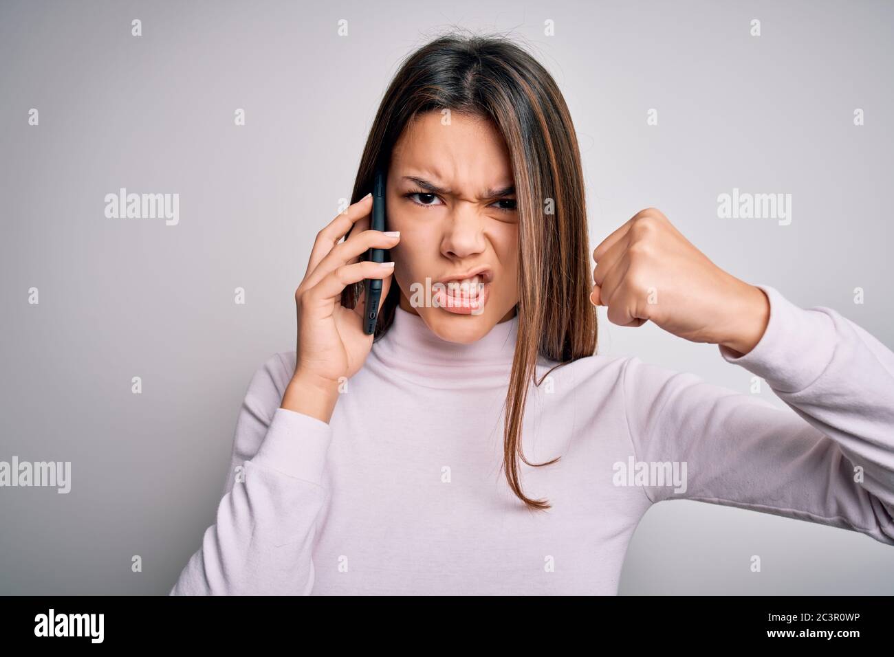 Beautiful brunette girl having conversation talking on the smartphone ...