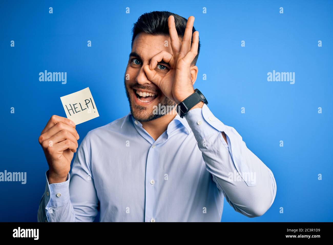 Young overworked business man asking for help holding paper over blue ...