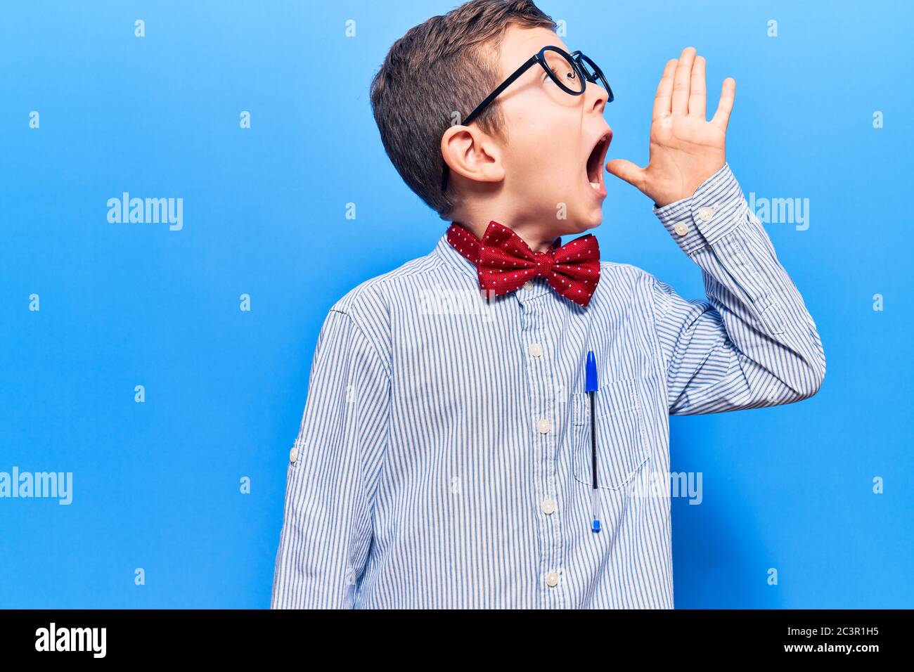 Cute blond kid wearing nerd bow tie and glasses shouting and screaming ...