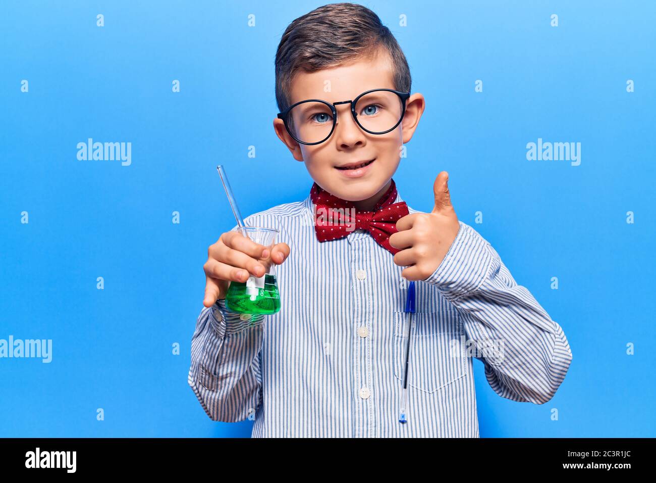 Cute blond kid wearing scientist bow tie and glasses holding test tube ...