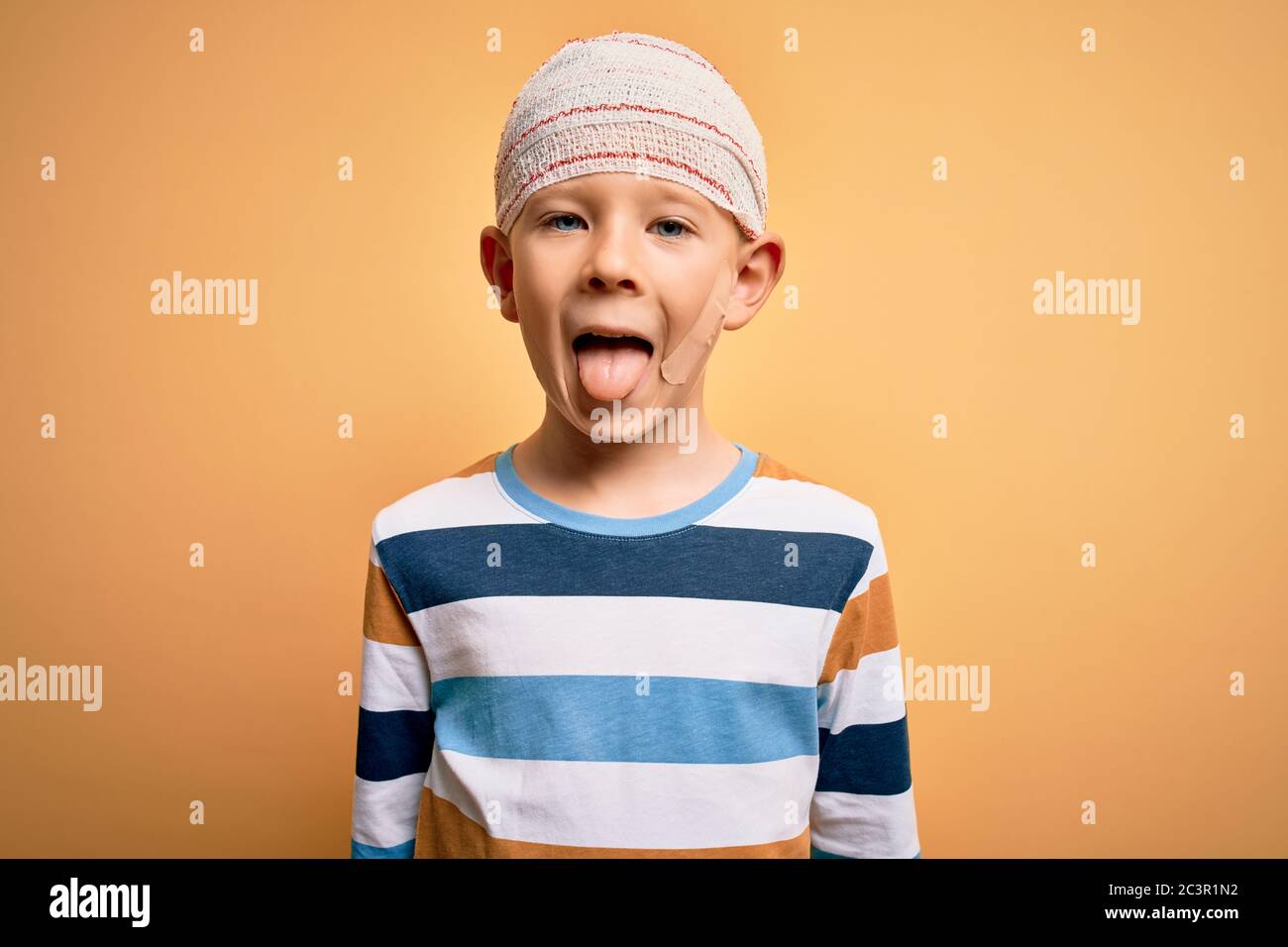 Young little caucasian kid injured wearing medical bandage on head over ...