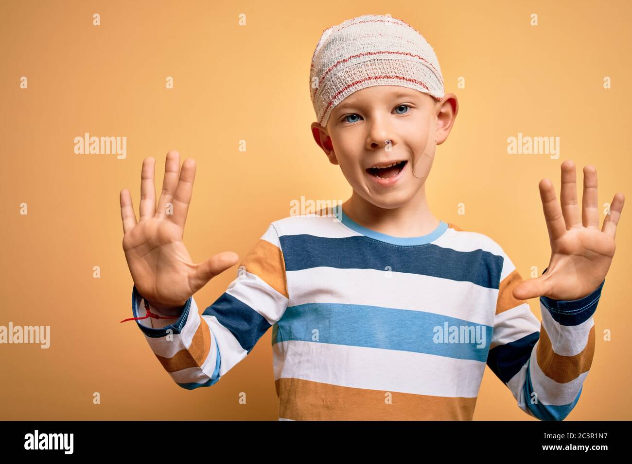Young little caucasian kid injured wearing medical bandage on head over ...