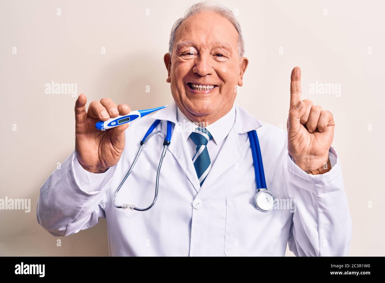 Senior grey-haired doctor man wearing stethoscope controlling ...
