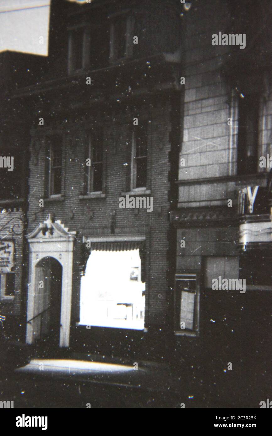 Fine 70s vintage black and white evening photography of a storefront ...