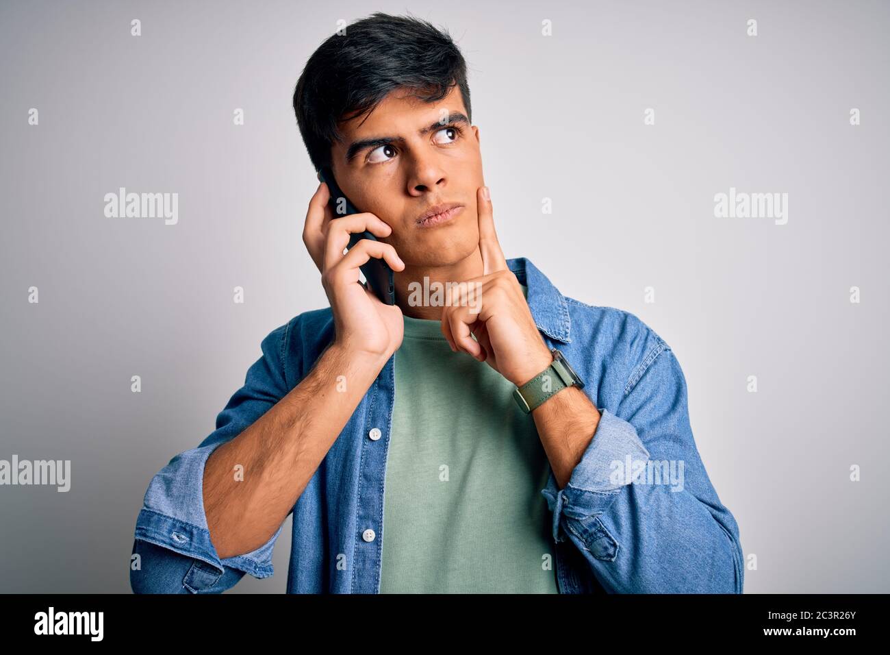 Young handsome man having conversation talking on the smartphone over ...