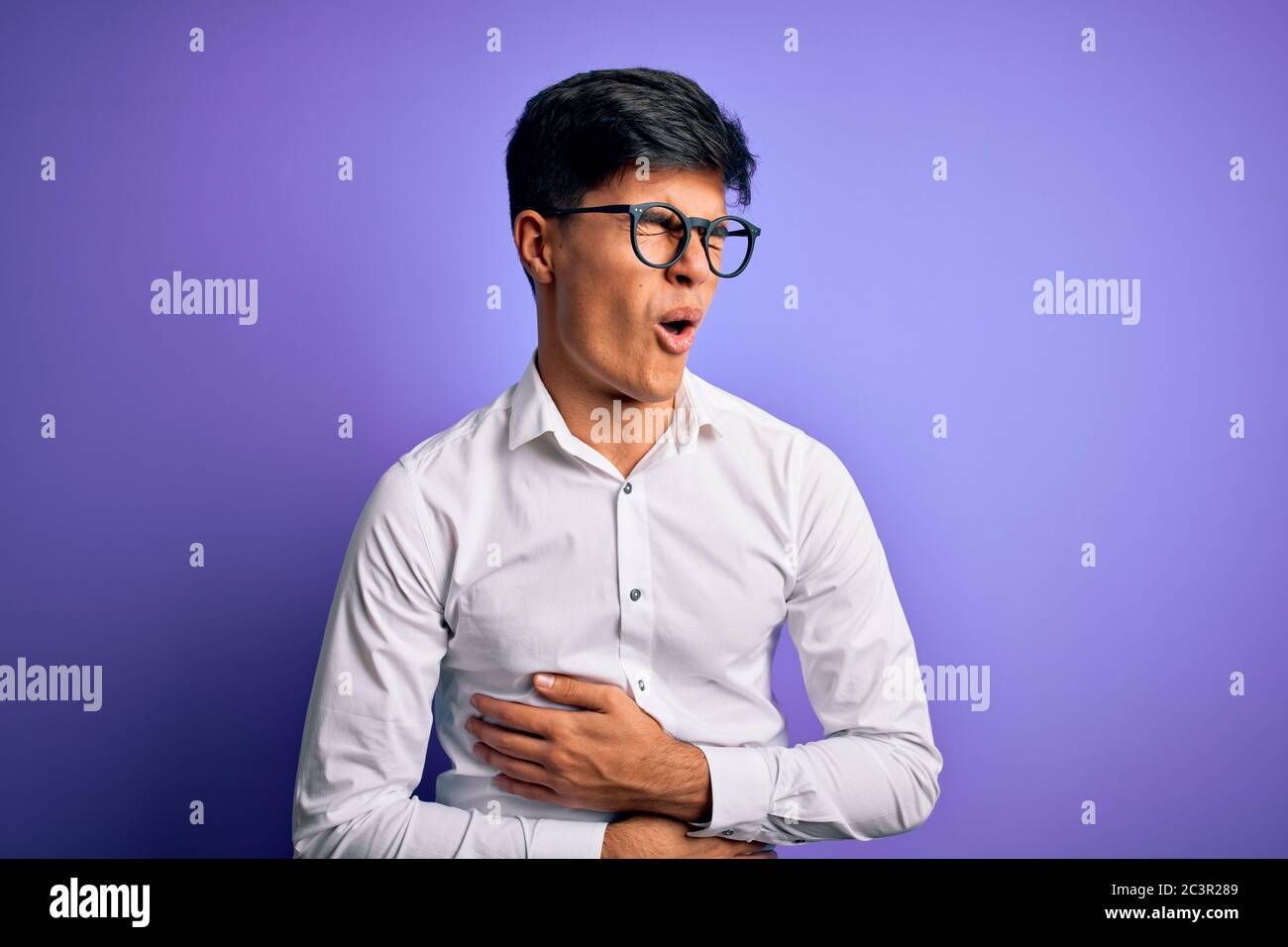 Young handsome business man wearing shirt and glasses over isolated ...