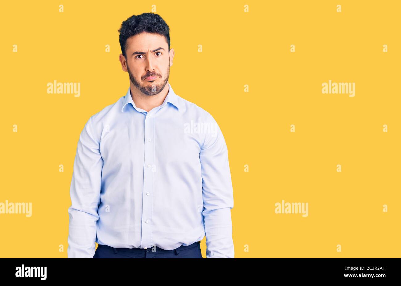 Young hispanic man wearing business clothes depressed and worry for ...