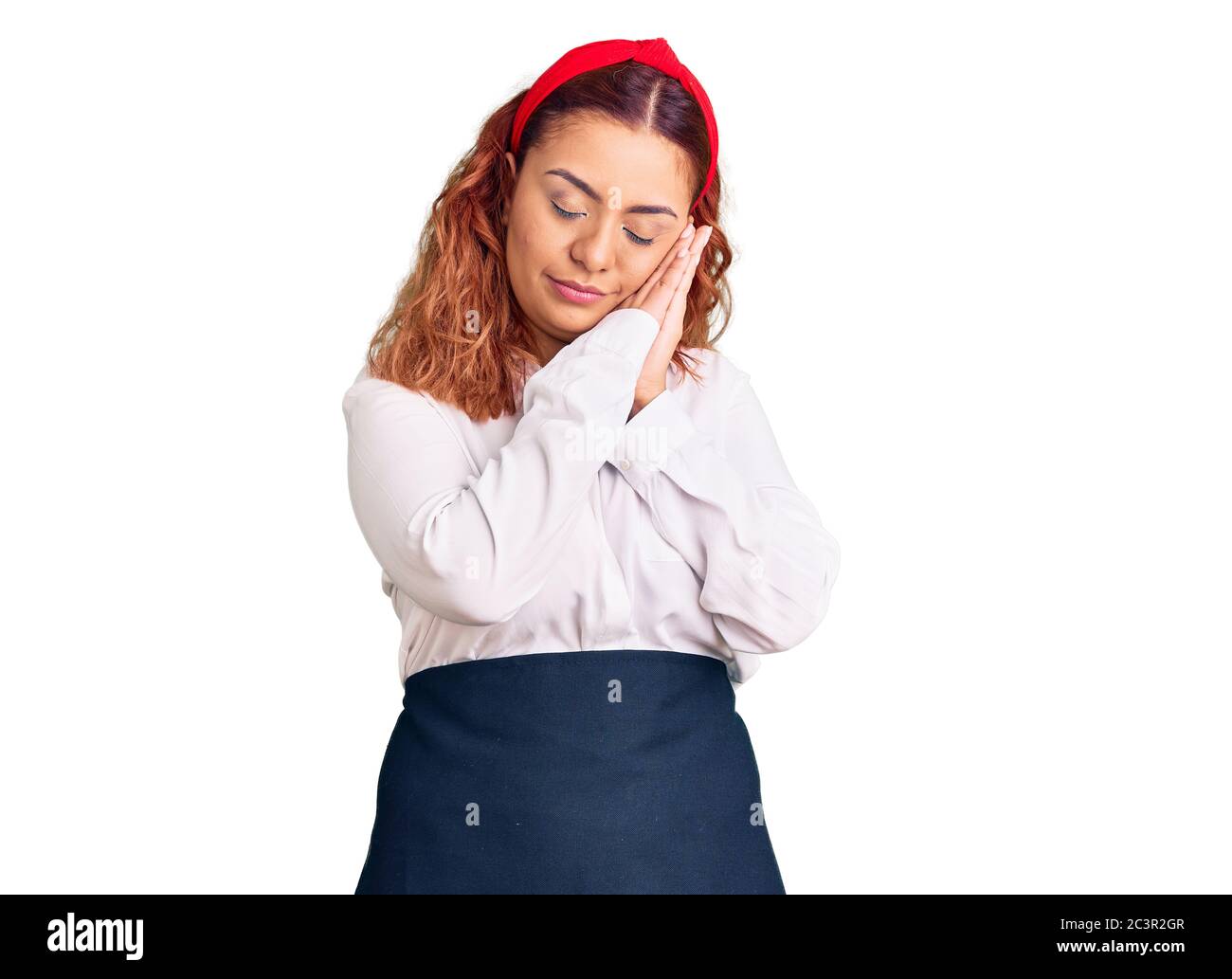 Young latin woman wearing waitress apron sleeping tired dreaming and ...