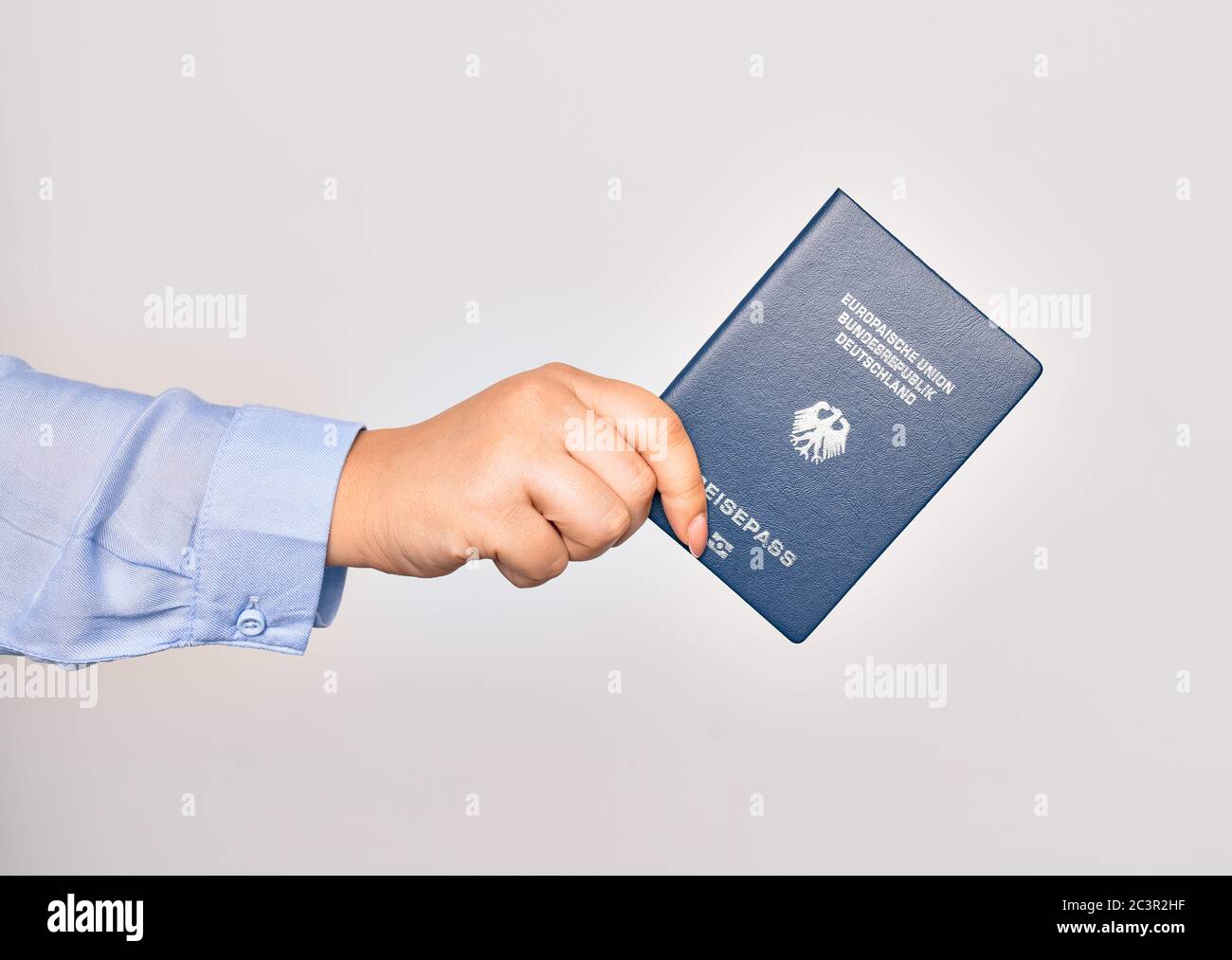 Hand of caucasian young woman holding Germany German passport document ...