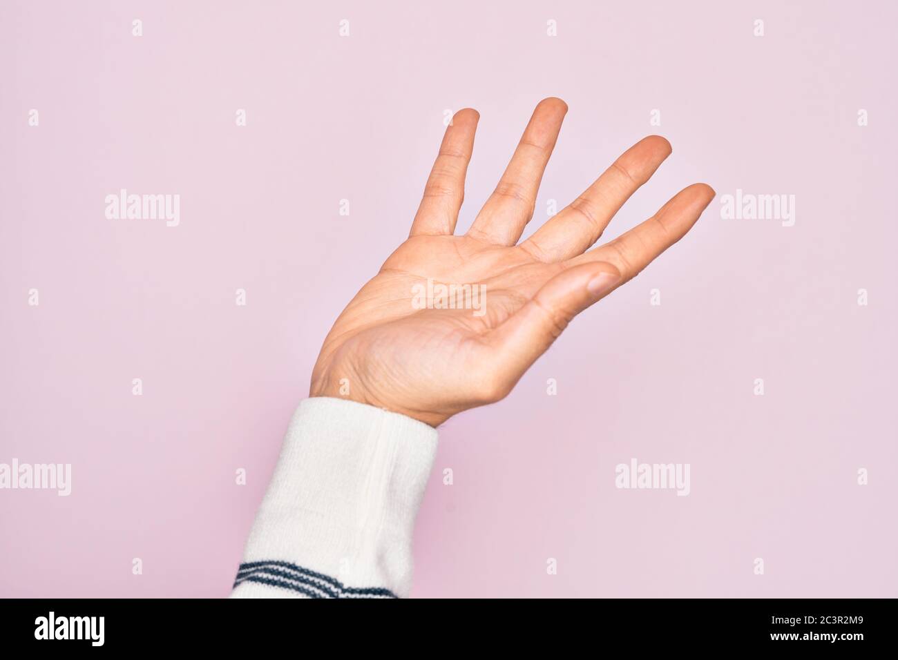Hand of caucasian young man showing fingers over isolated pink ...