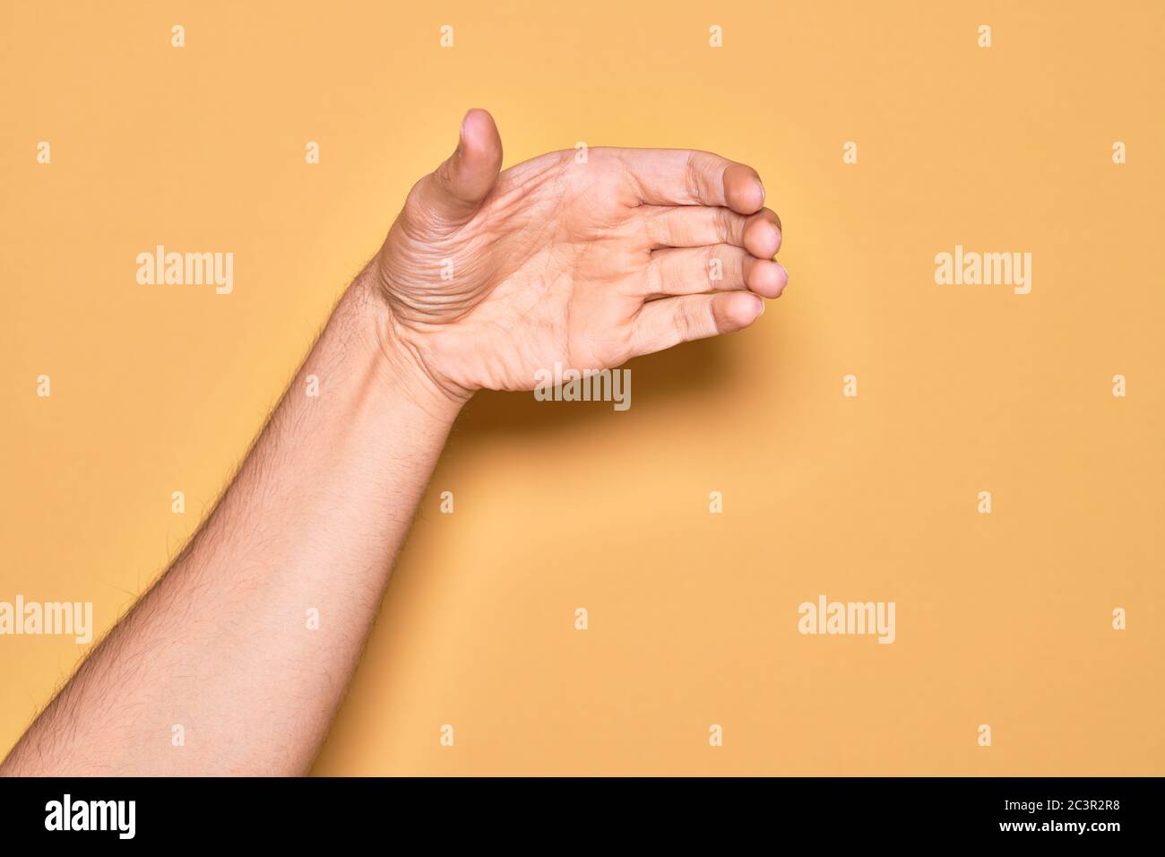 Hand of caucasian young man showing fingers over isolated yellow ...