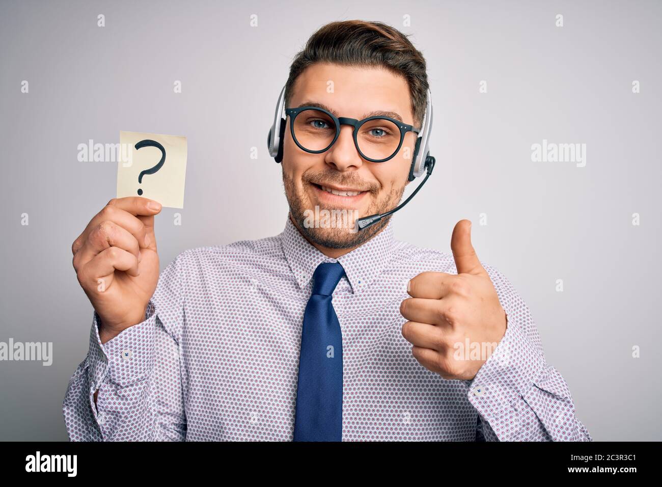 Young call center operator business man with blue eyes holding paper ...