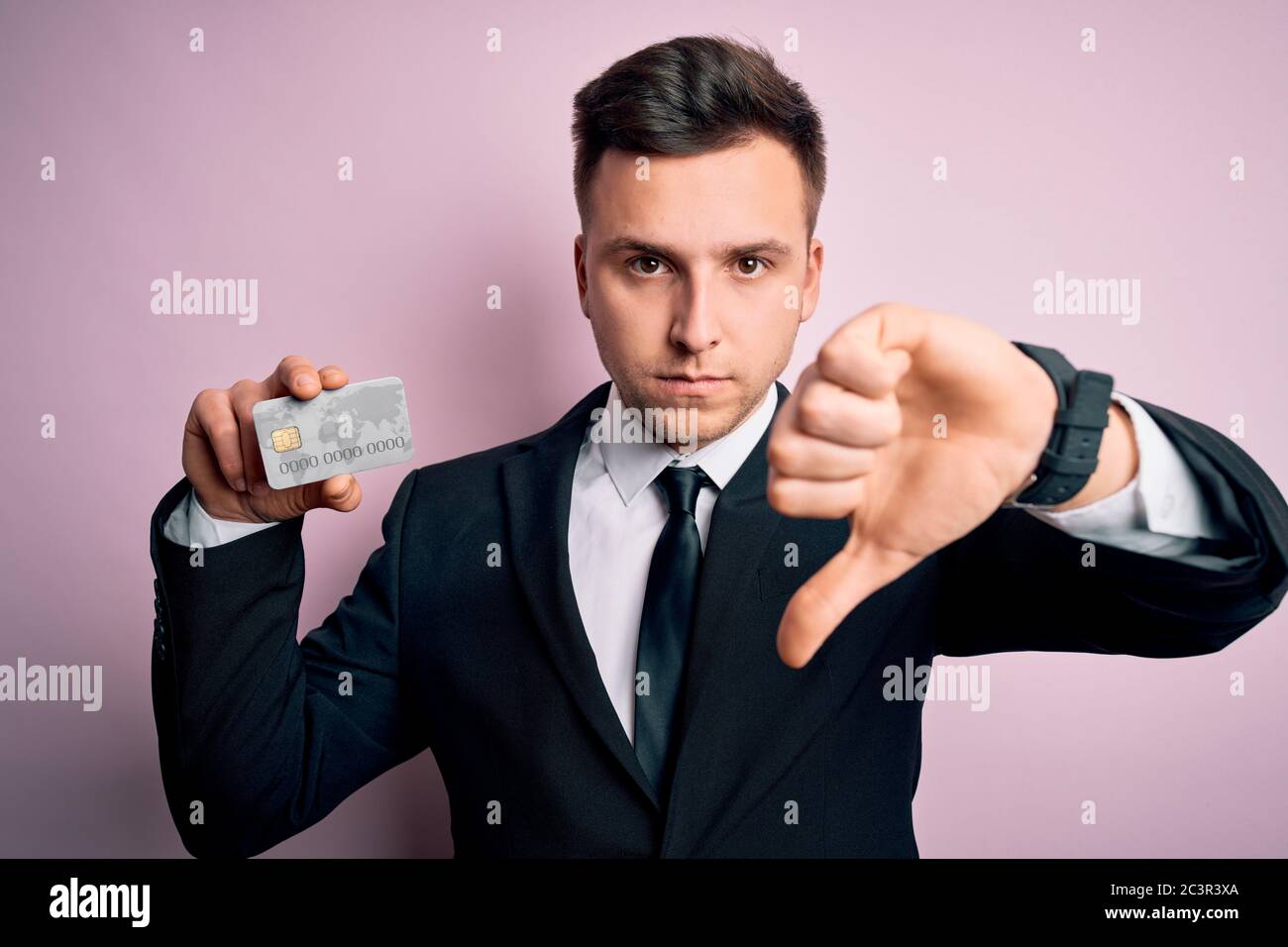 Young handsome caucasian business man holding finance credit card over ...