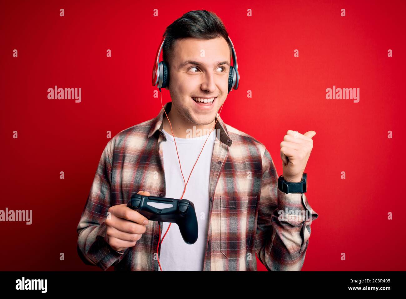 Young handsome caucasian gamer man playing video games using console ...