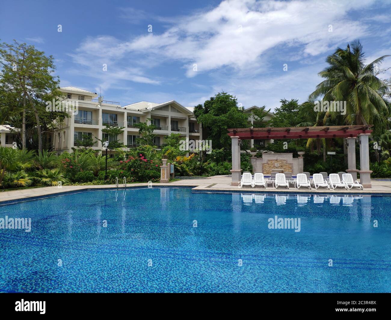 Blue swimming pool in hotel resort under the blue sky Stock Photo - Alamy
