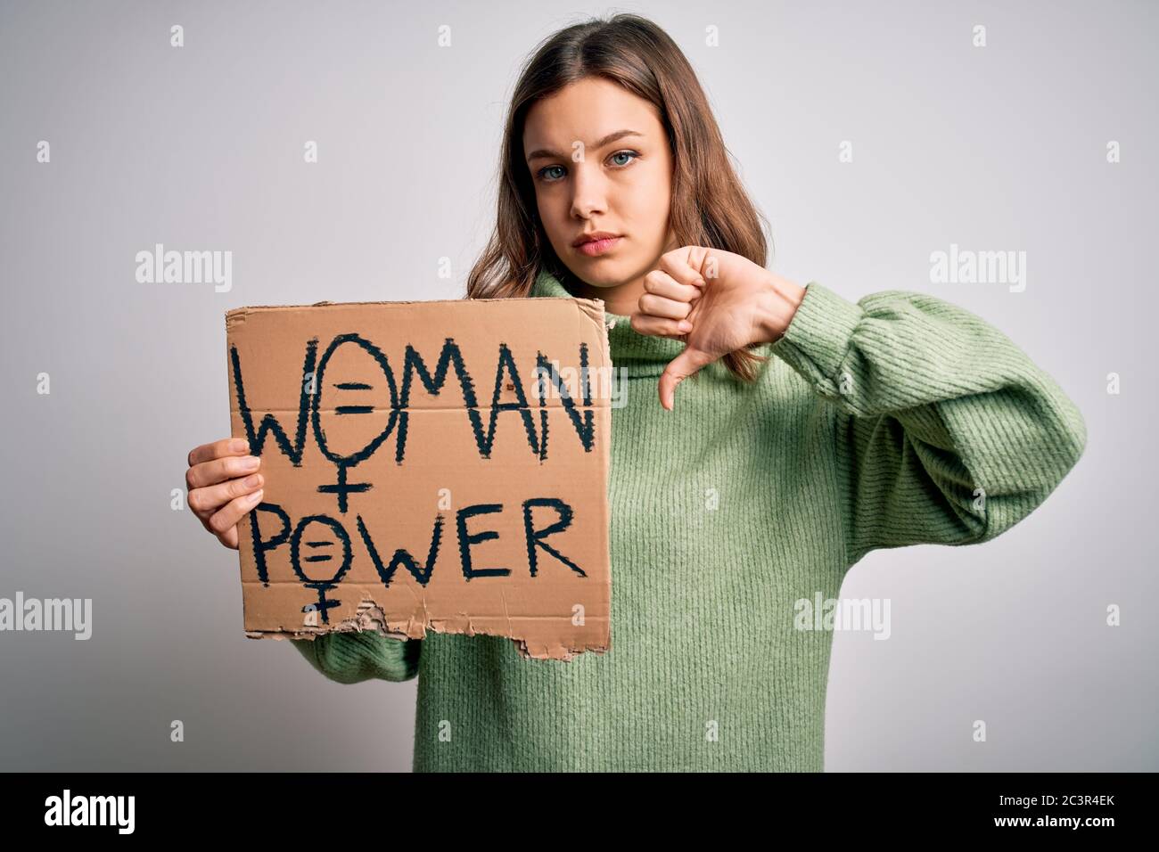 Young blonde girl holding protest banner for woman power and rights ...