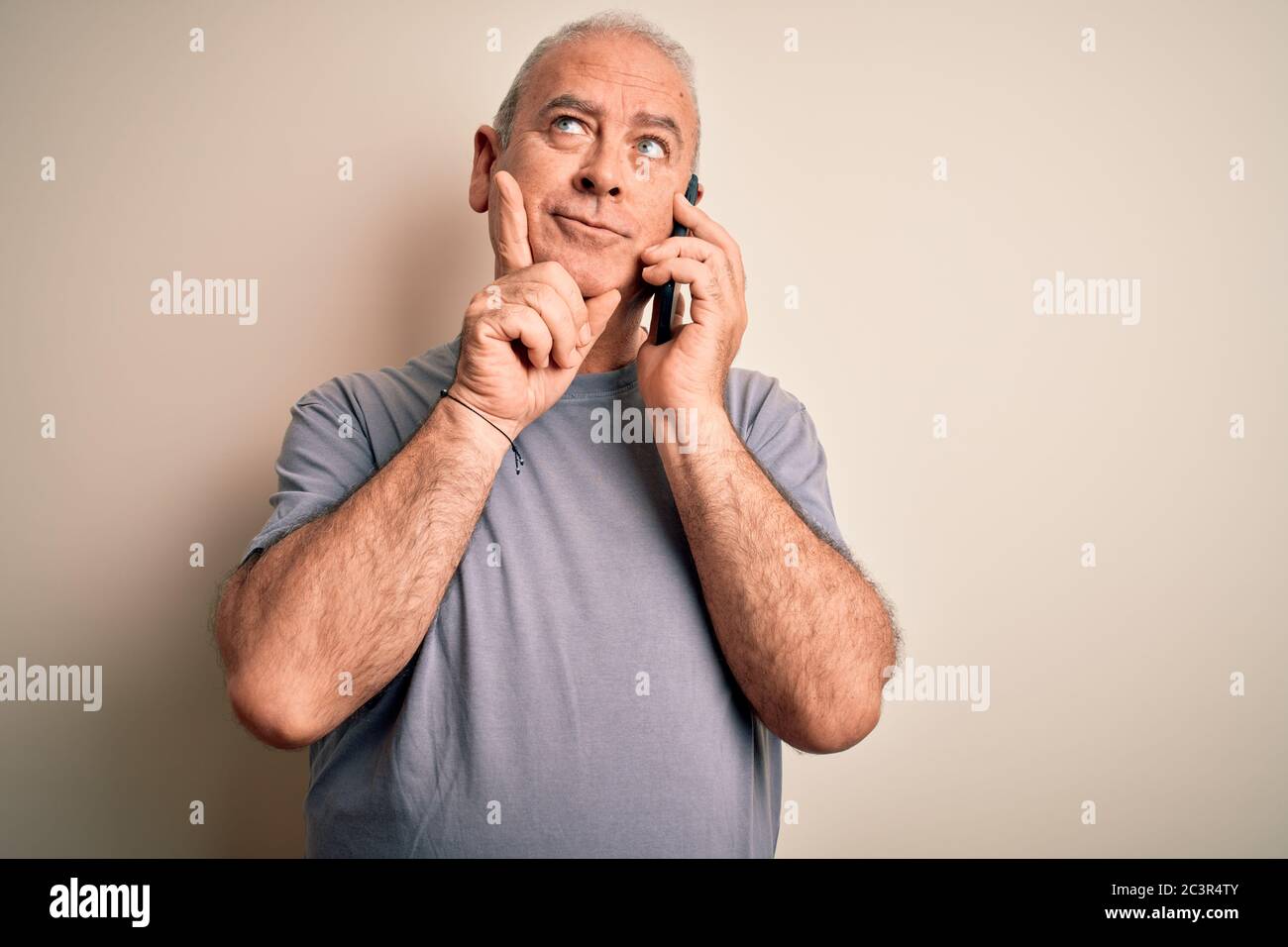 Middle age hoary man having conversation talking on the smartphone over ...