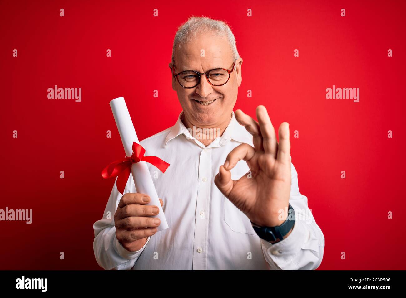 Middle age hoary student man wearing glasses holding university ...