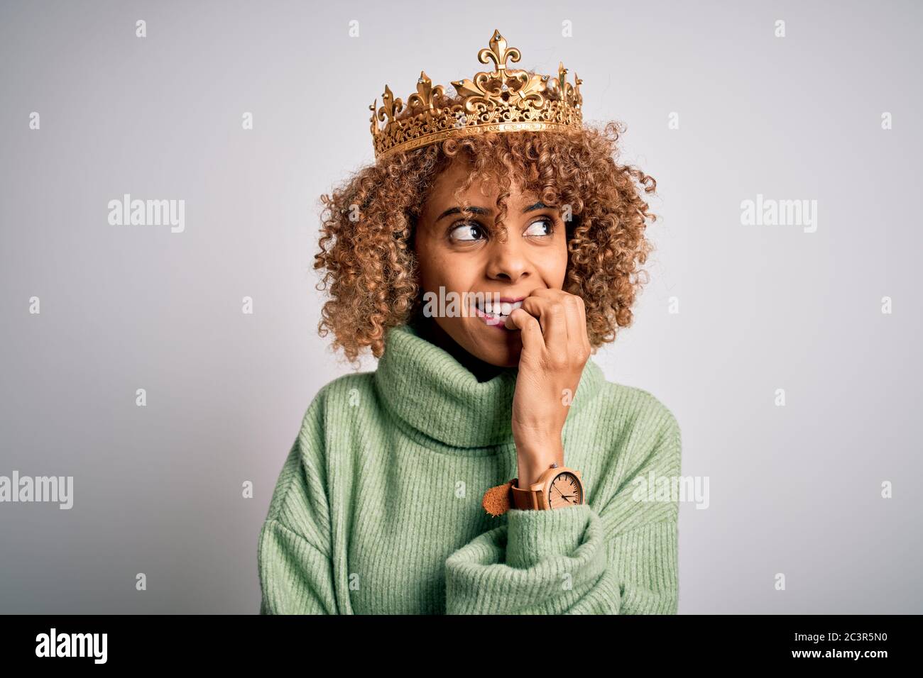 Young african american woman wearing golden crown of queen over ...