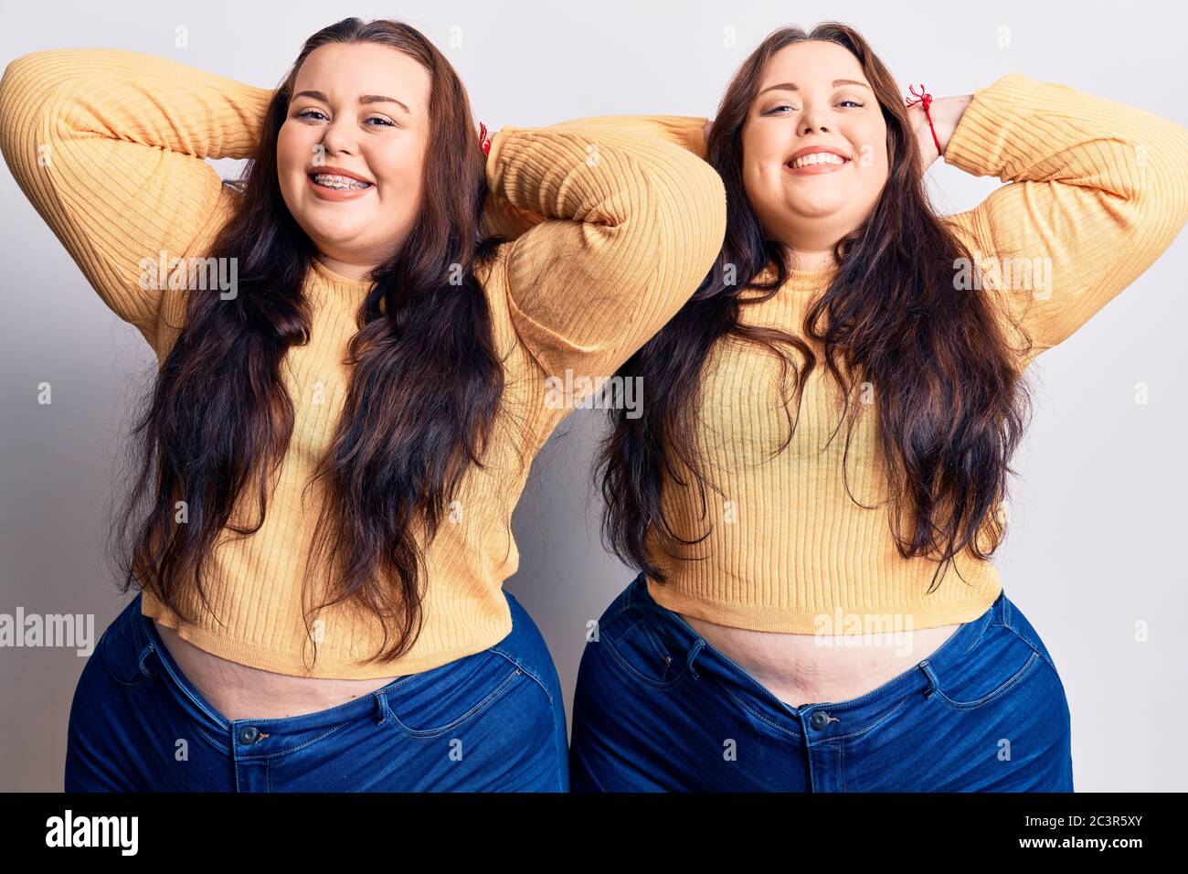 Young plus size twins wearing casual clothes relaxing and stretching ...