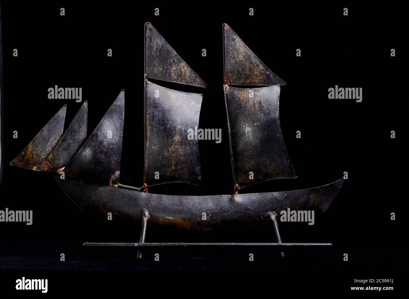Metal Sailing Boat Figurine on a Black Background Stock Photo - Alamy
