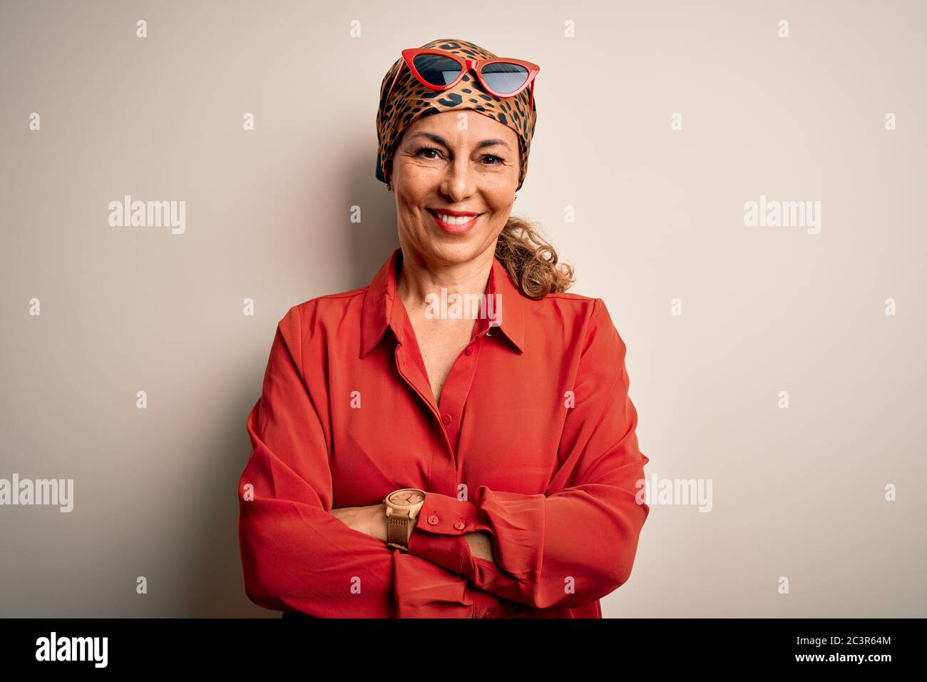 Middle age brunette woman wearing handkerchief on head and shirt over ...