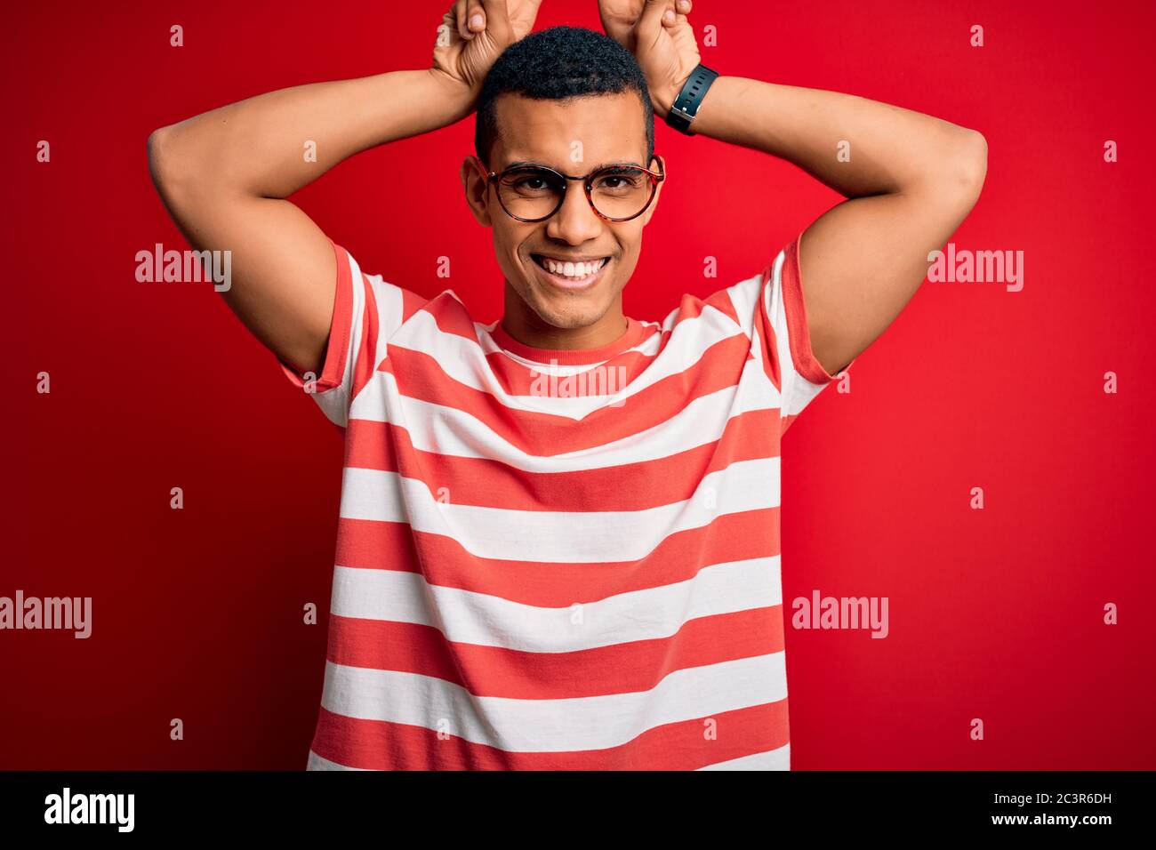 Young handsome african american man wearing casual striped t-shirt and ...
