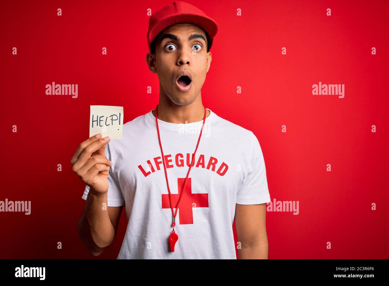 Young handsome african american lifeguard man wearing whistle holding ...