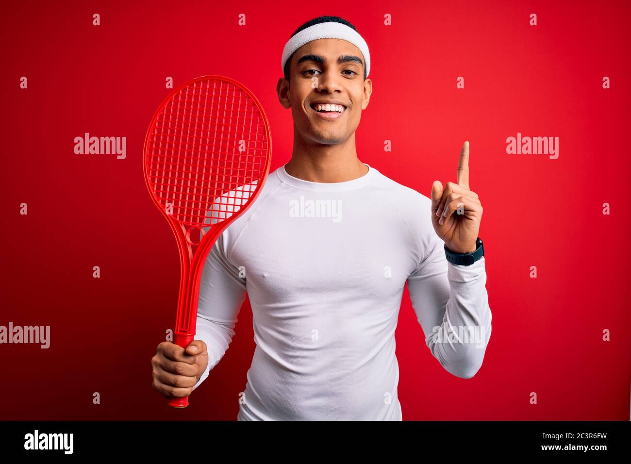 Young handsome african american sportsman playing tennis using racket ...