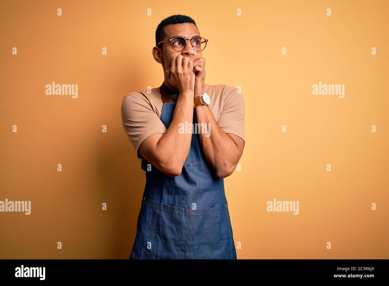 Young handsome african american shopkeeper man wearing apron over ...