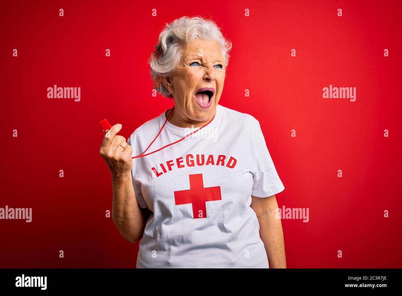 Senior beautiful grey-haired lifeguard woman wearing t-shirt with red ...