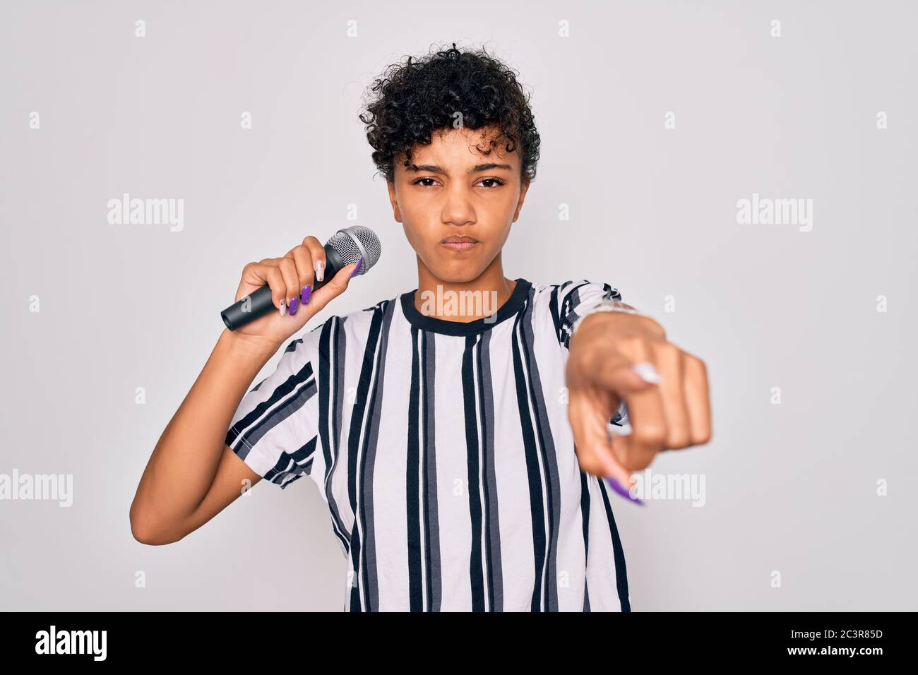 Beautiful african american afro singer woman singing using microphone ...
