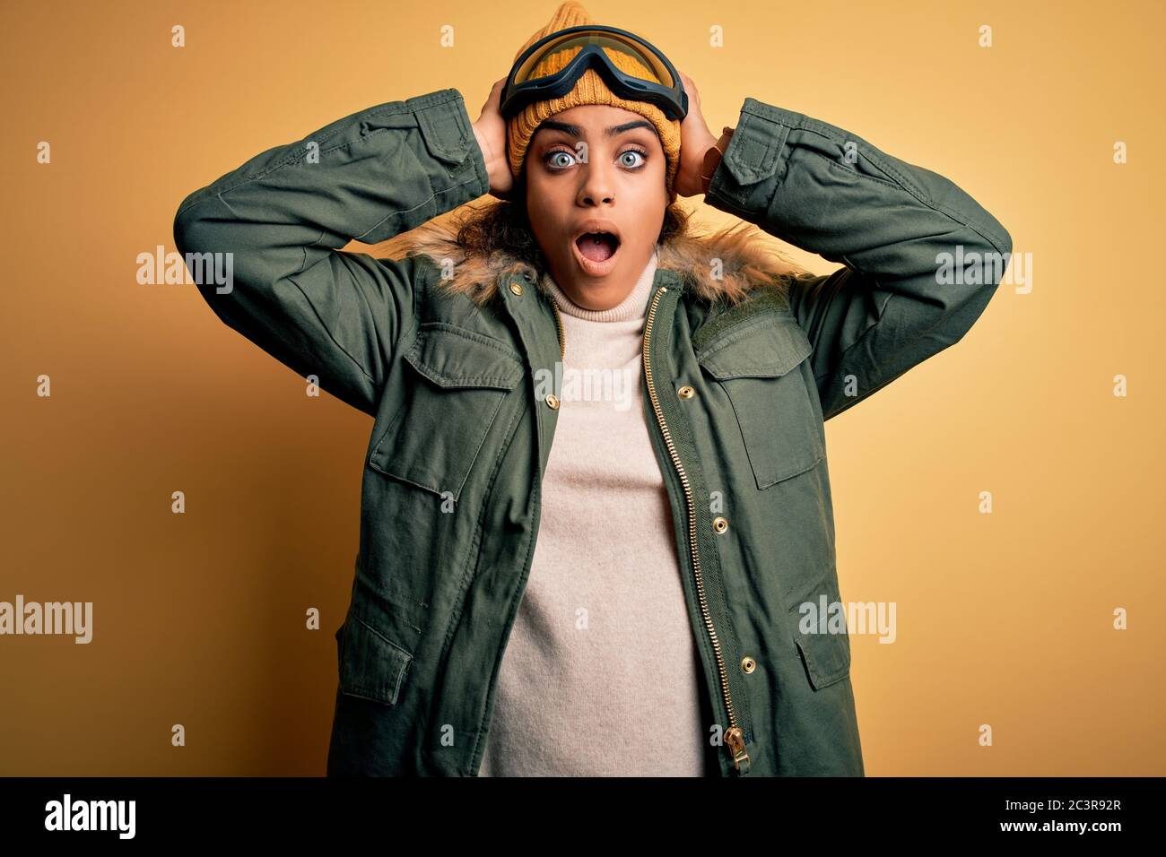 Young african american afro skier girl wearing snow sportswear and ski ...