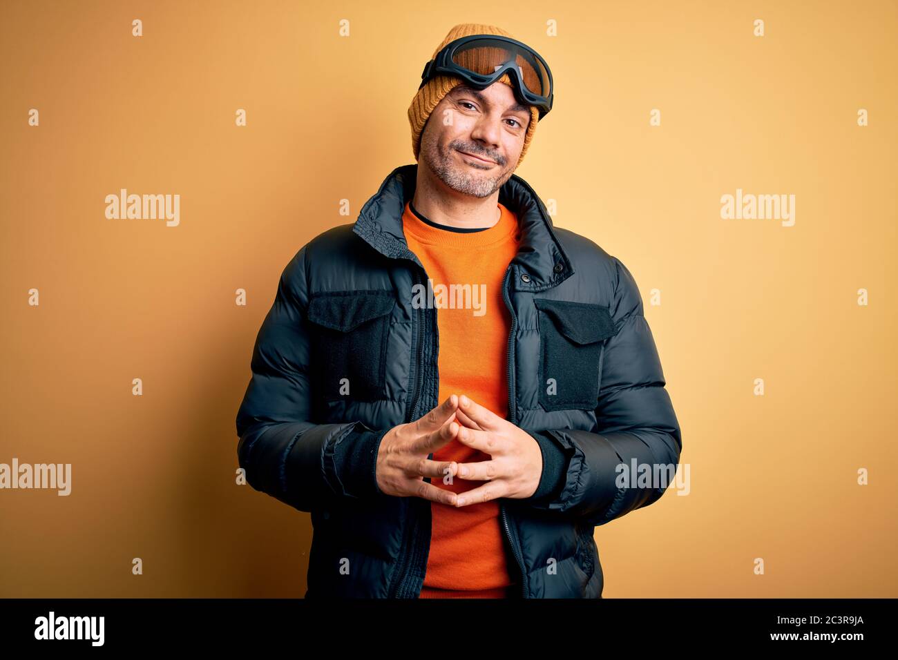 Young handsome skier man skiing wearing snow sportswear using ski ...