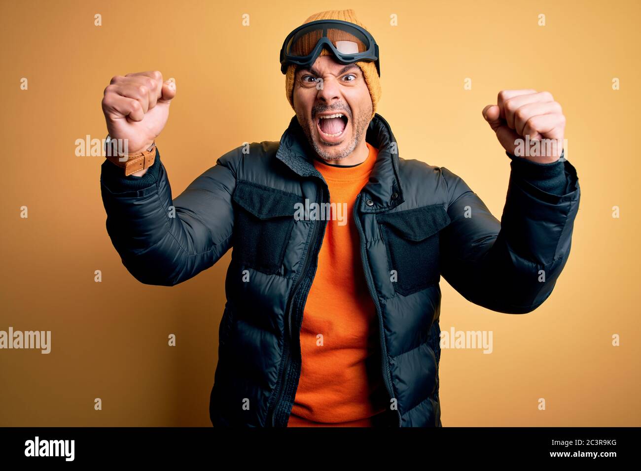 Young handsome skier man skiing wearing snow sportswear using ski ...