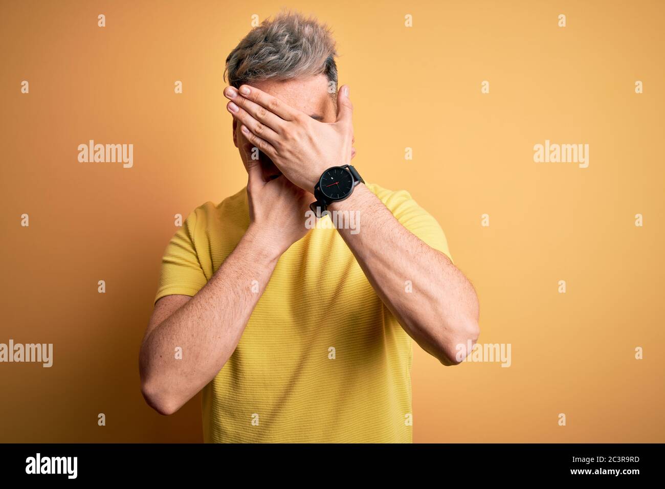 Young handsome modern man wearing yellow shirt over yellow isolated ...